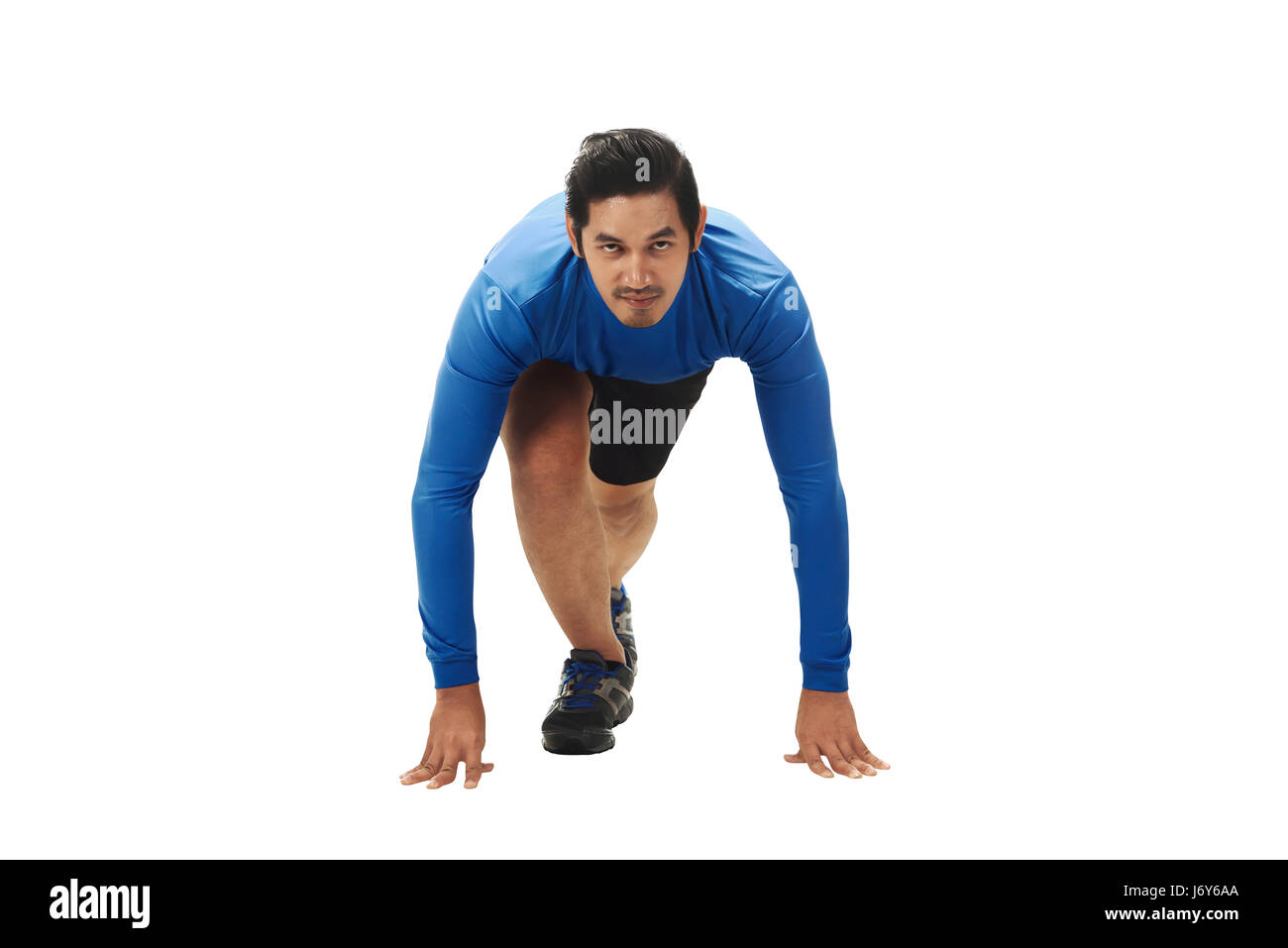 Young asian man on ready position to run isolated over white background ...
