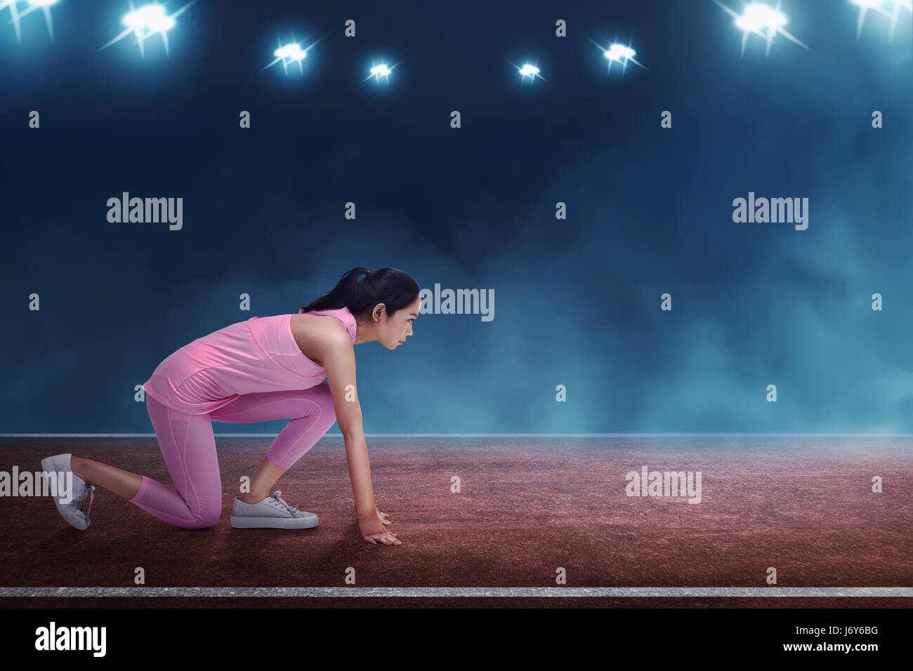 Beautiful asian woman athlete ready to running in starting line at ...