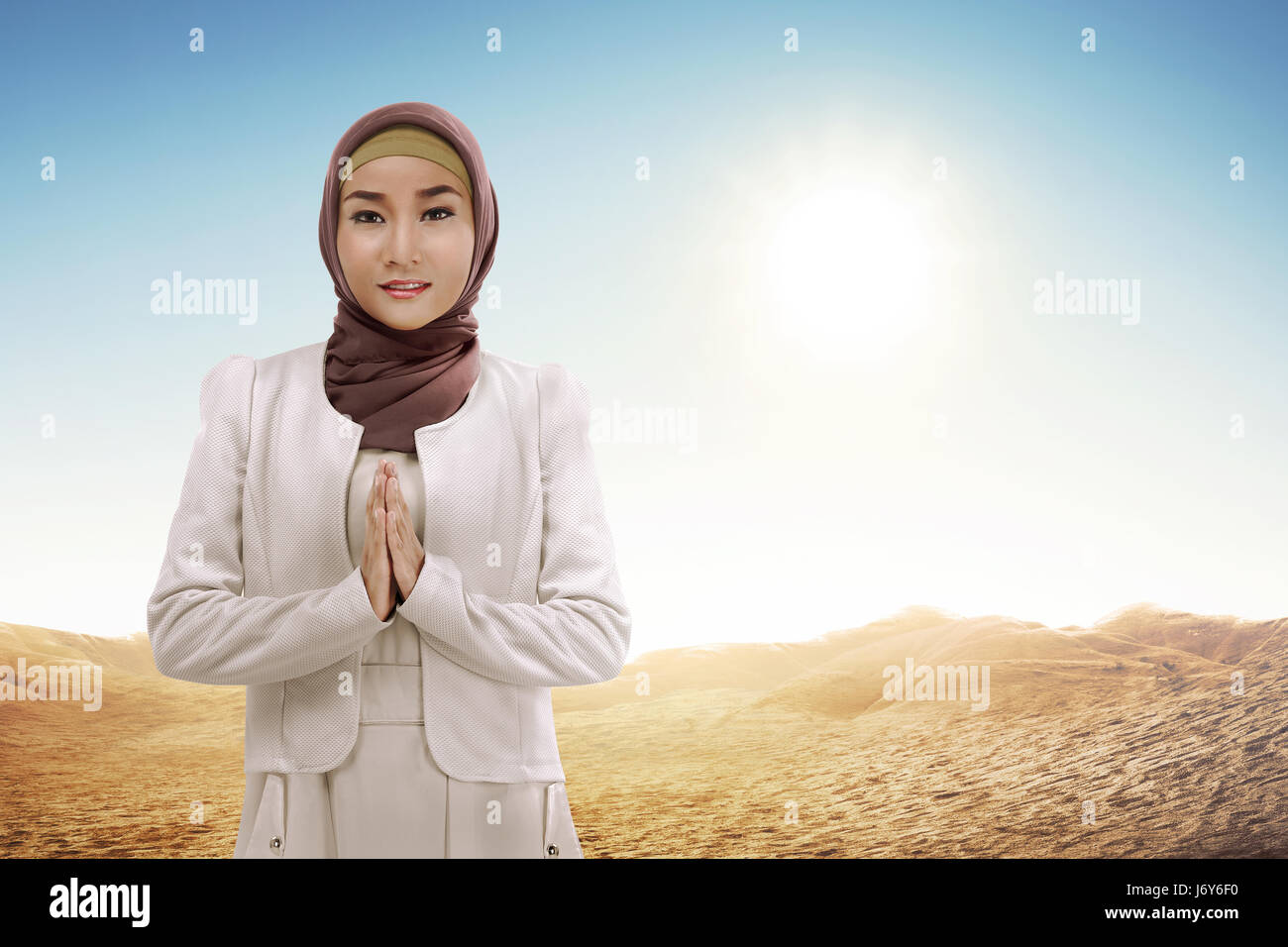 Young asian muslim woman in hijab with smiley face standing at desert ...