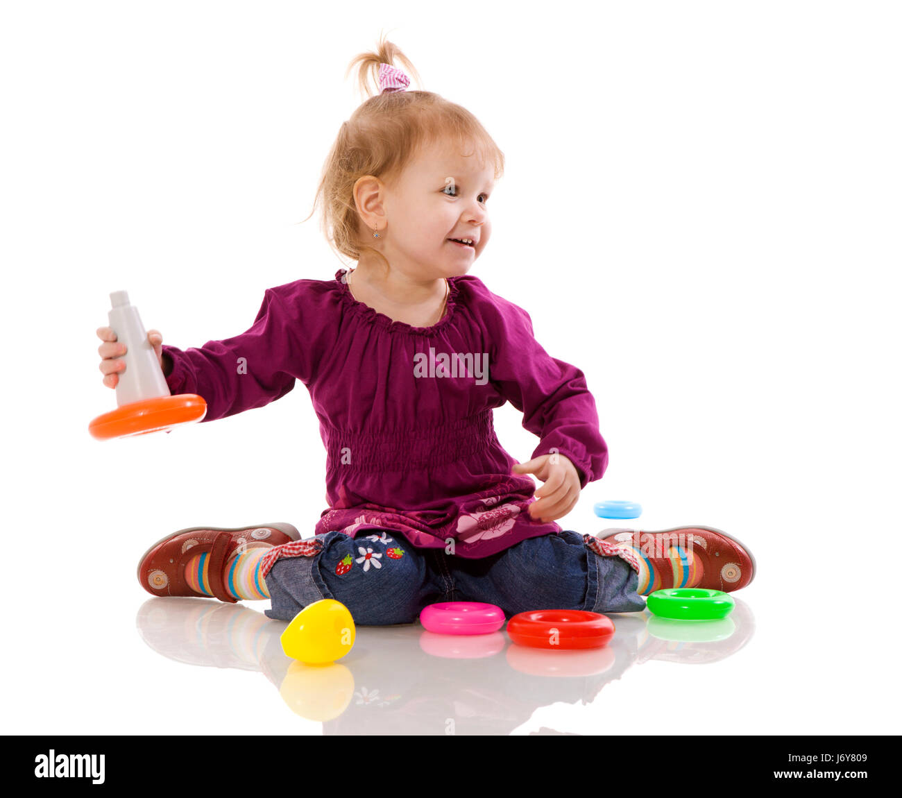 Little girl playing with pyramid isolated on white Stock Photo - Alamy
