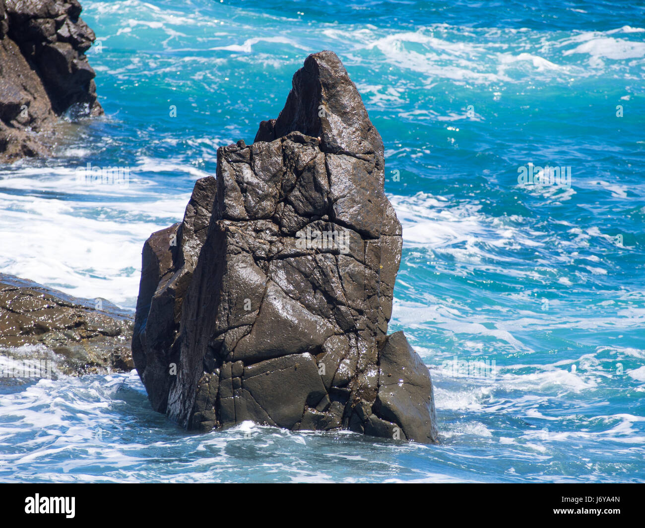 Large Rock In The Ocean Stock Photo - Alamy