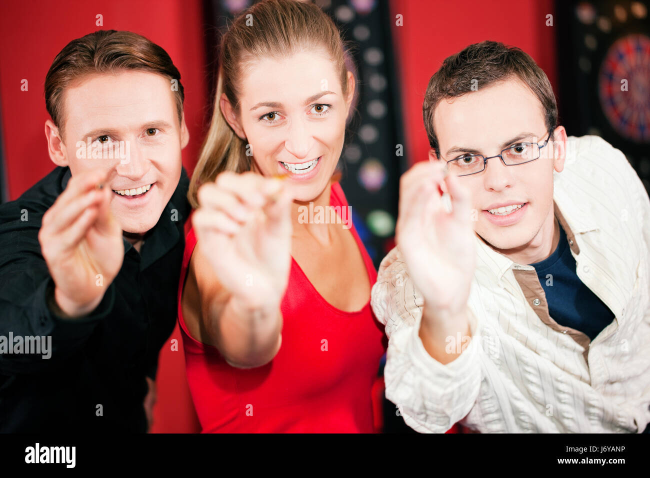 group of friends playing darts Stock Photo - Alamy