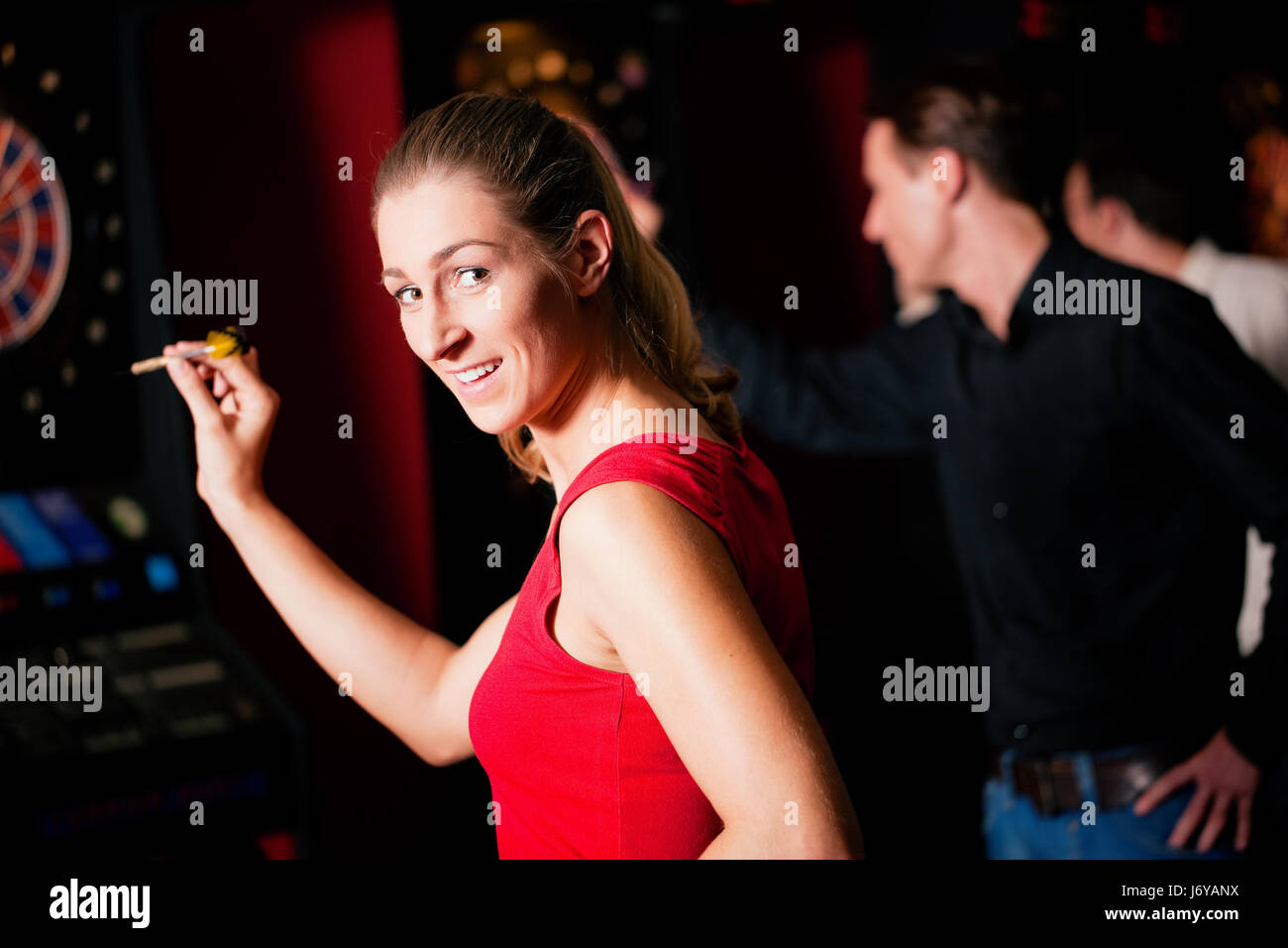 group of friends playing darts Stock Photo - Alamy