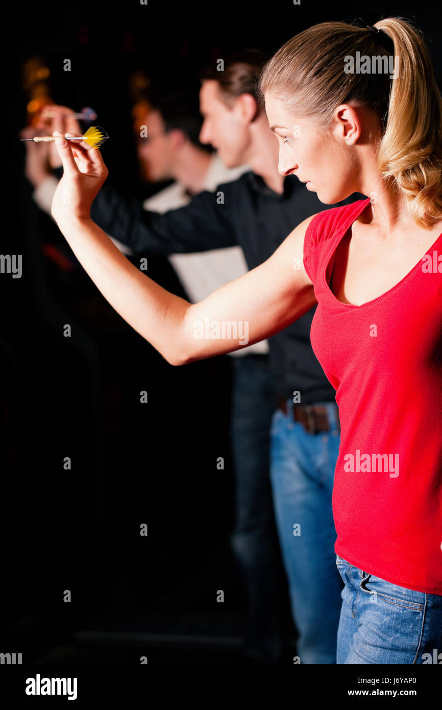 group of friends playing darts Stock Photo - Alamy