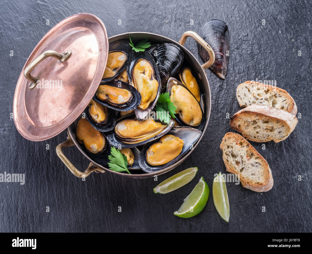 Boiled mussels in copper pan on the graphite background Stock Photo - Alamy