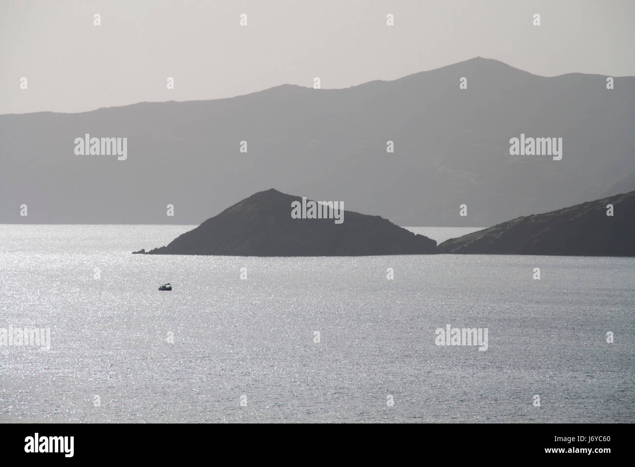 evening rock twilight fisherman salt water sea ocean water rowing boat ...