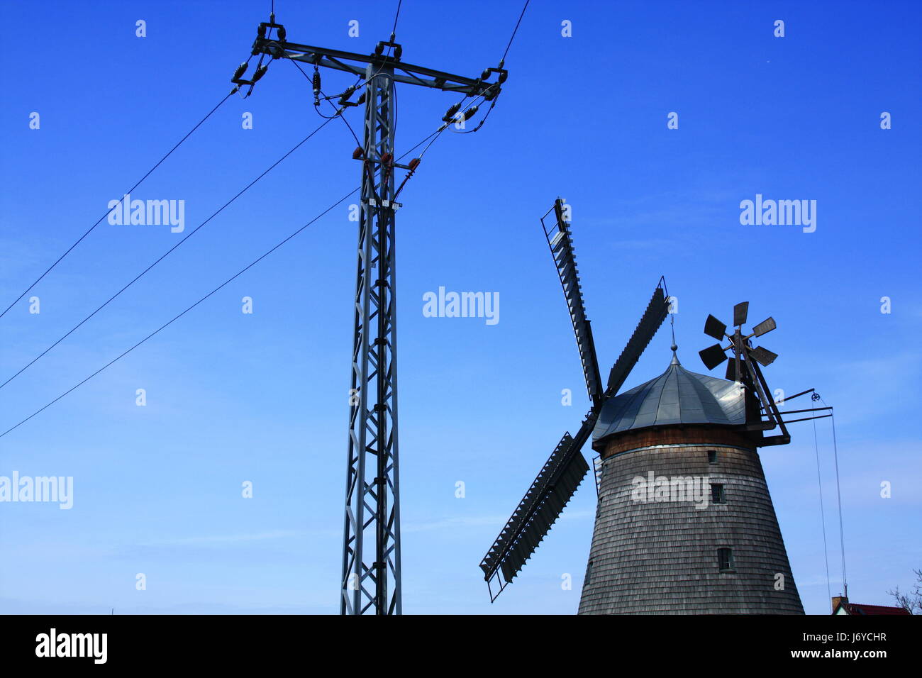 windmill and pylon Stock Photo - Alamy