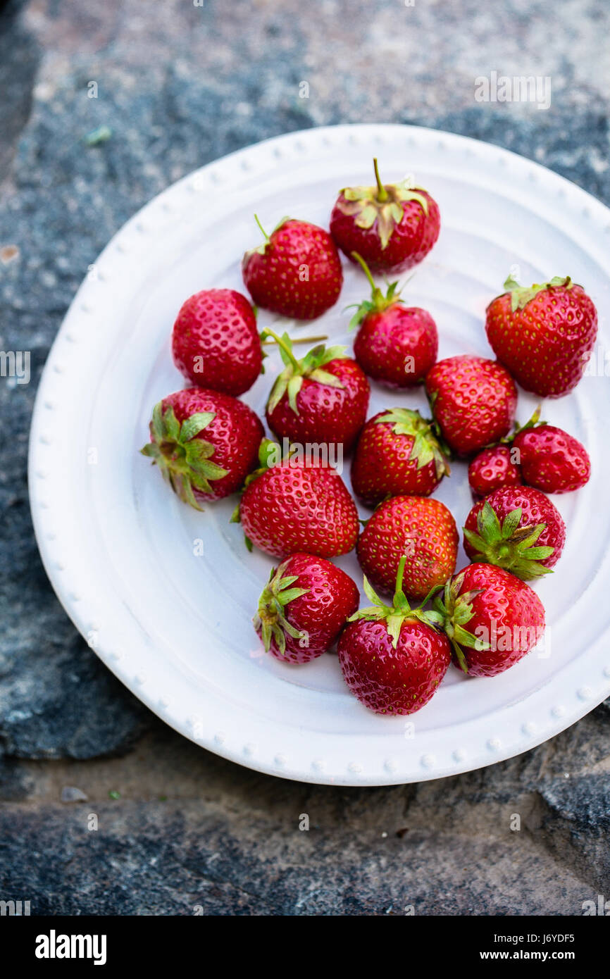 Strawberries on stone, rustic Stock Photo - Alamy