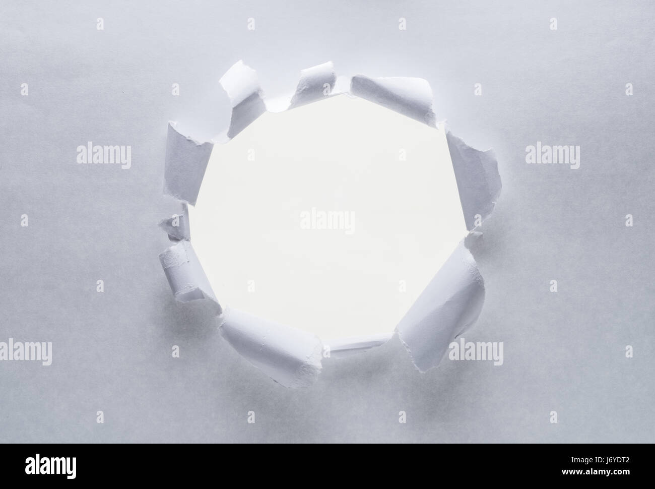 Hole on a paper. White background Stock Photo - Alamy
