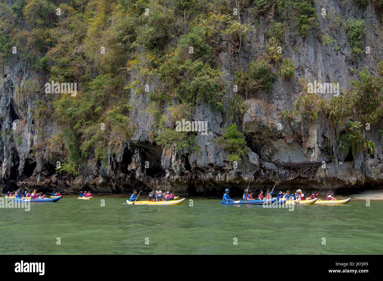 Tourists kayaking among limestone islands Stock Photo - Alamy