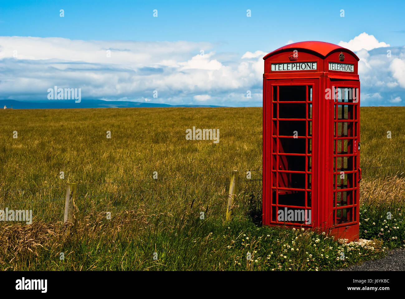red phone booth in landscape v3 Stock Photo - Alamy