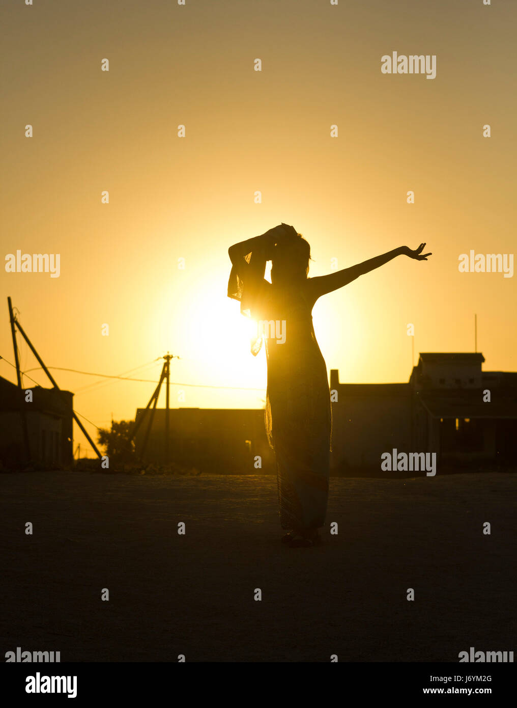 girl's silhouette against the sun at sunset Stock Photo - Alamy