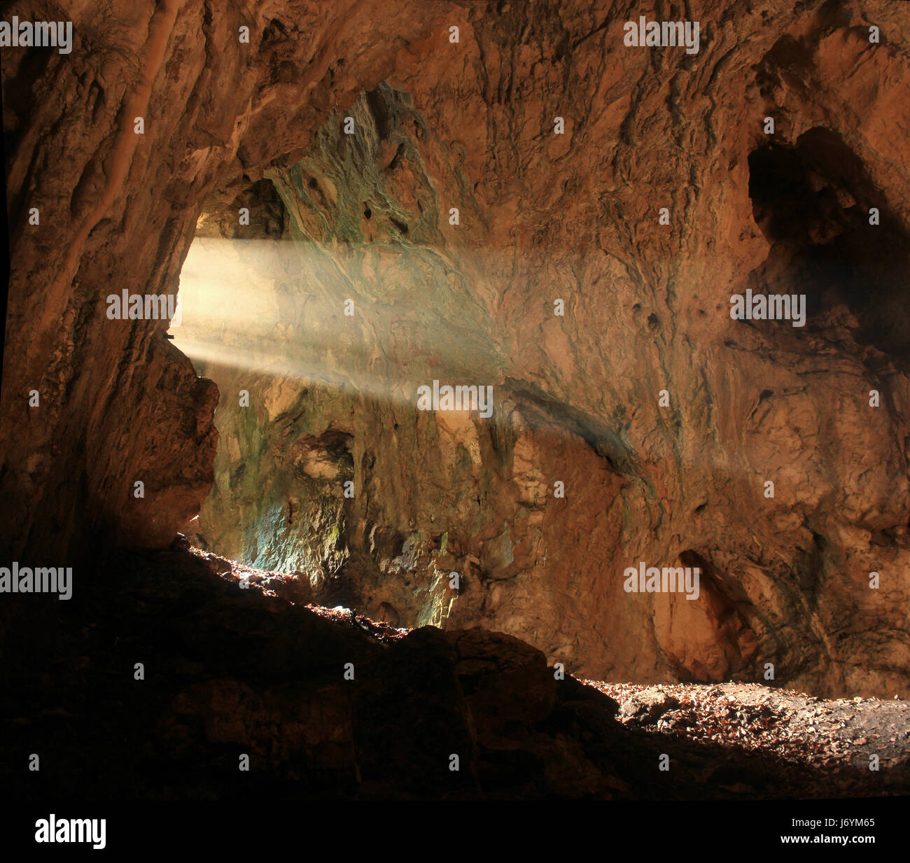 big cave with bright sunbeam from entrance Stock Photo - Alamy