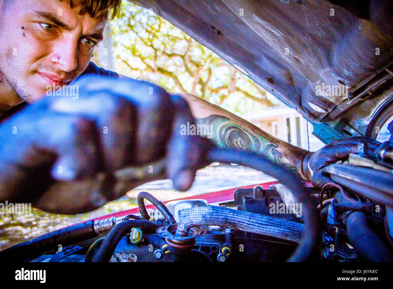Mechanic working on a car Stock Photo - Alamy