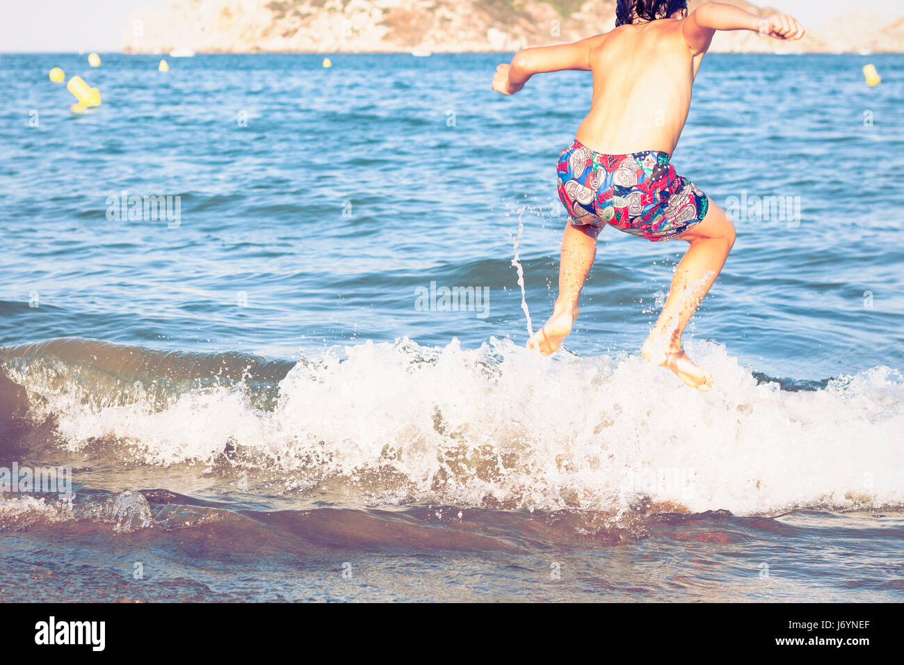 Boys Jumping Into Waves High Resolution Stock Photography and Images ...