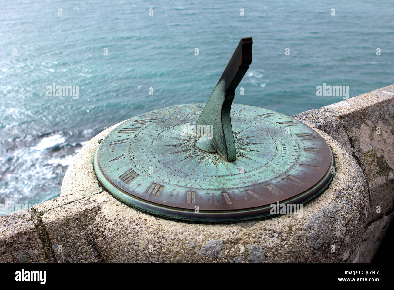 Antique sundial on a stone wall overlooking the sea Stock Photo - Alamy