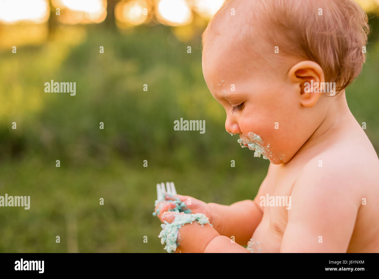 Portrait of a baby boy with cake on his face Stock Photo - Alamy