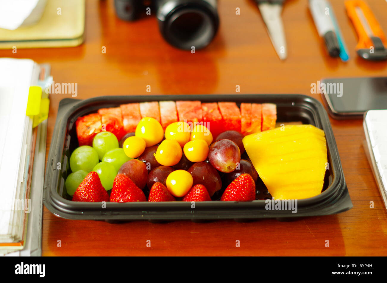 Close up of a healthy breakfast, fruit salad packed in plastic box on ...