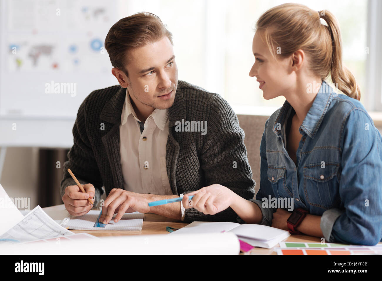 Delighted happy woman giving a pen to her colleague Stock Photo - Alamy