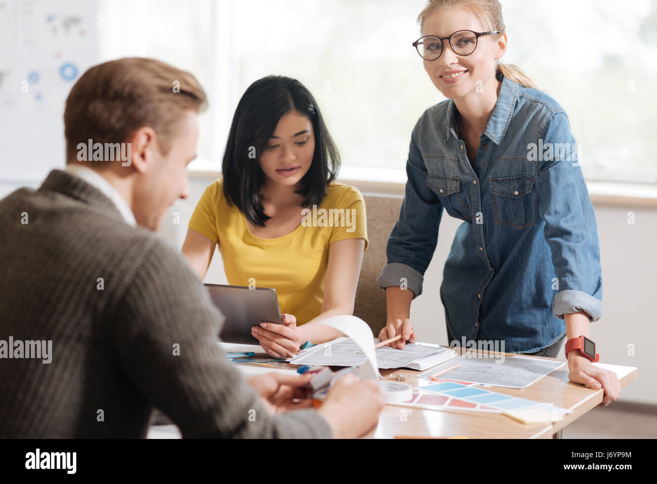Cheerful positive woman leaning on the table Stock Photo - Alamy