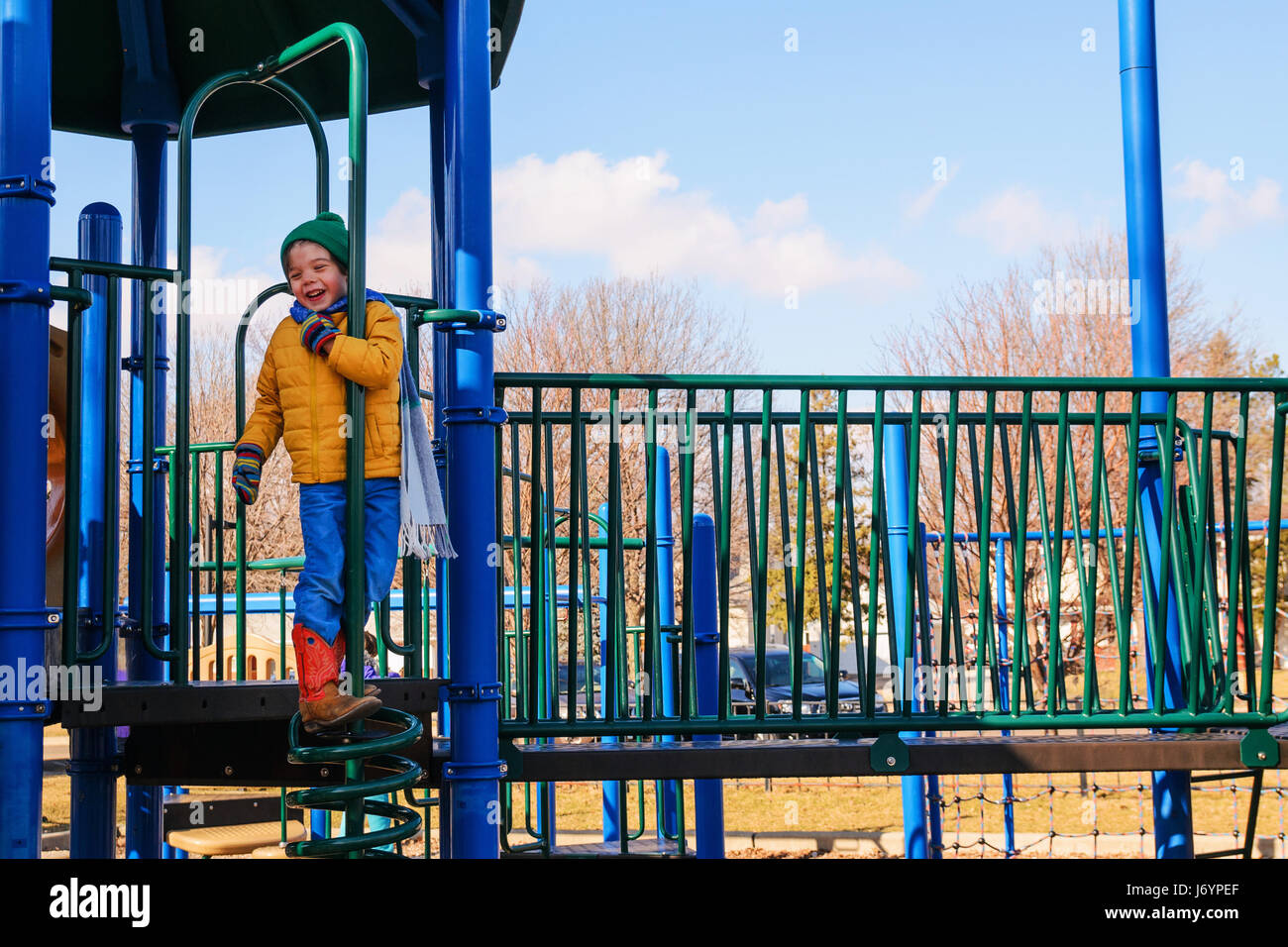 Boy playing a playground Stock Photo - Alamy