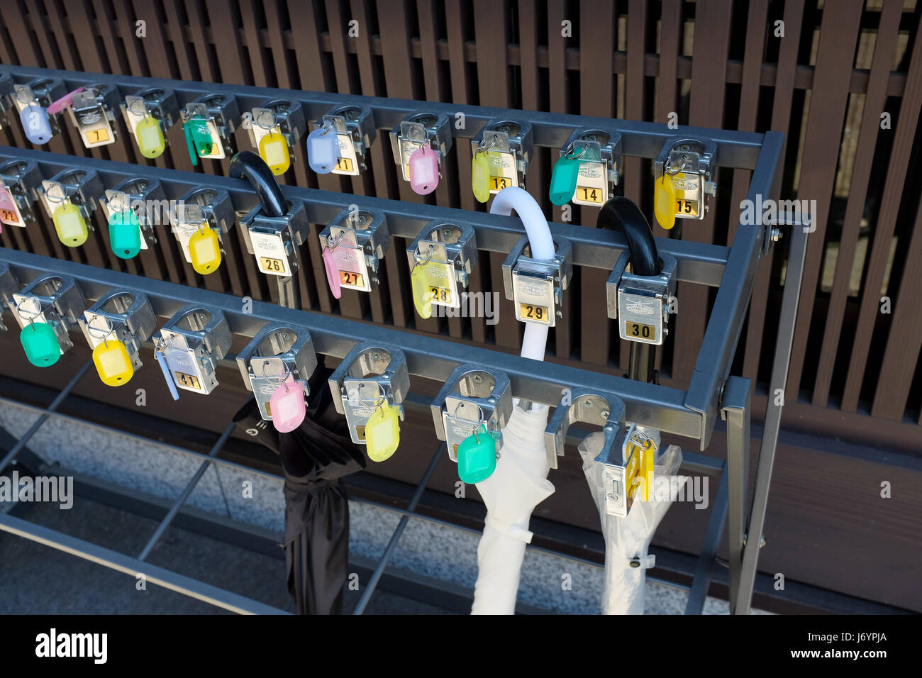 A rack outside a restaurant where you can lock your umbrella Stock ...