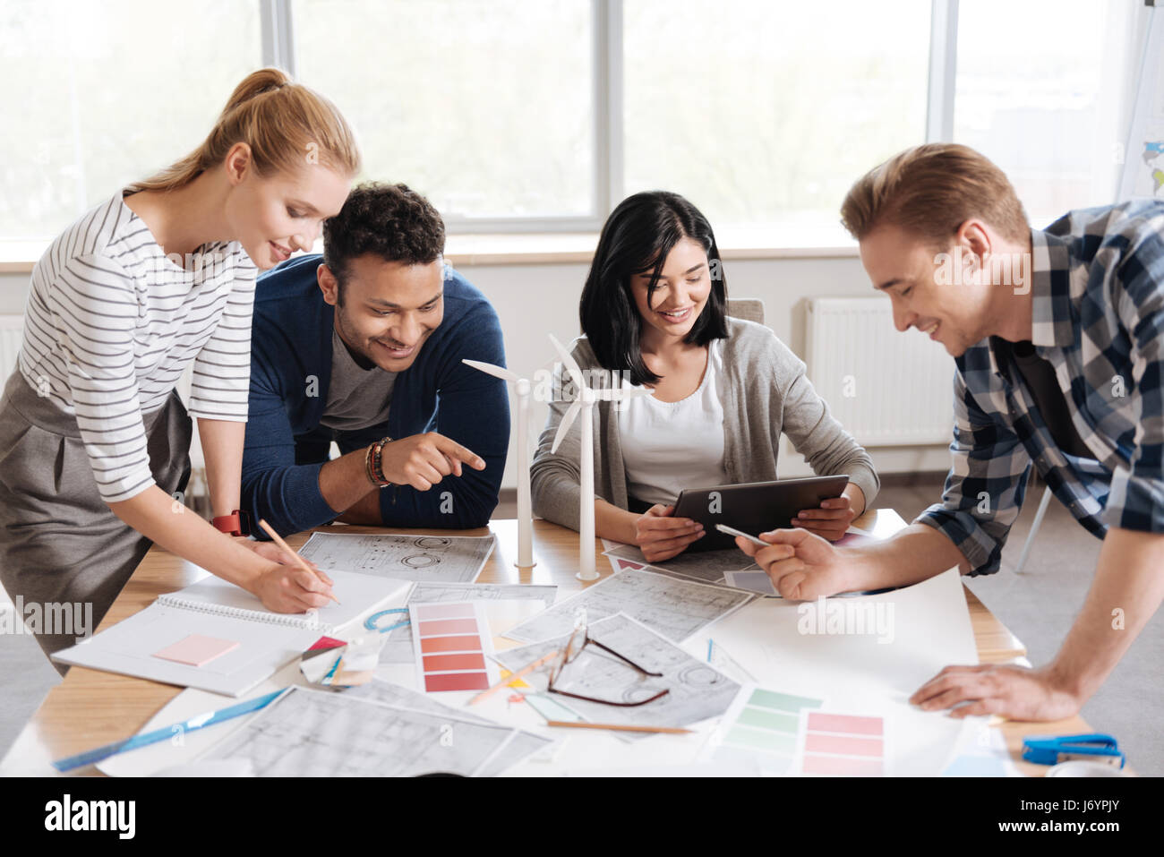 Happy positive engineers working together Stock Photo - Alamy