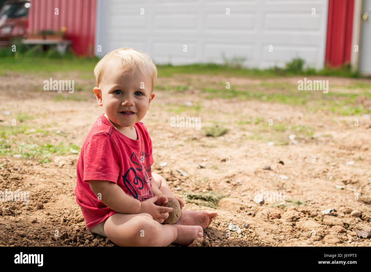 Child playing in mud hi-res stock photography and images - Alamy