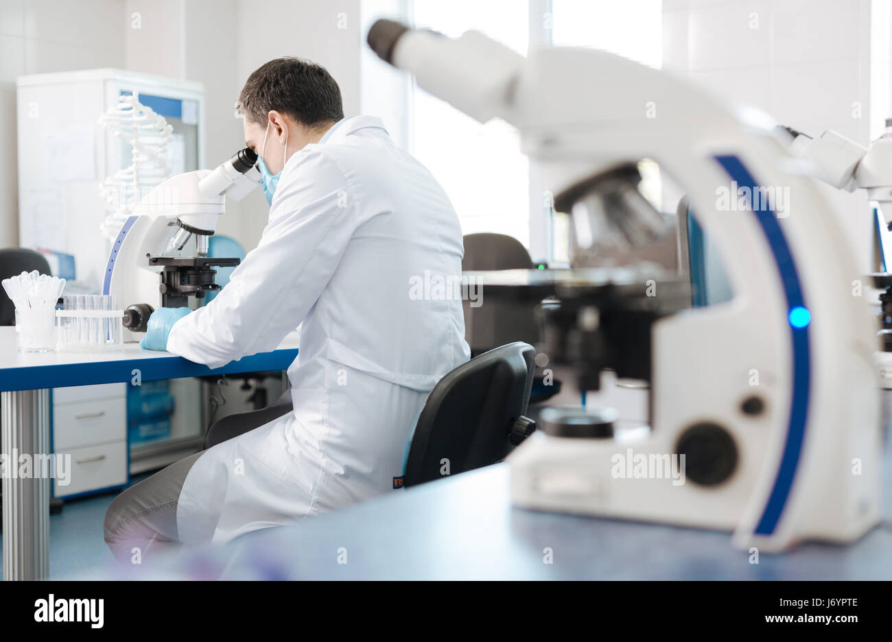 Confident researcher looking into ocular Stock Photo - Alamy
