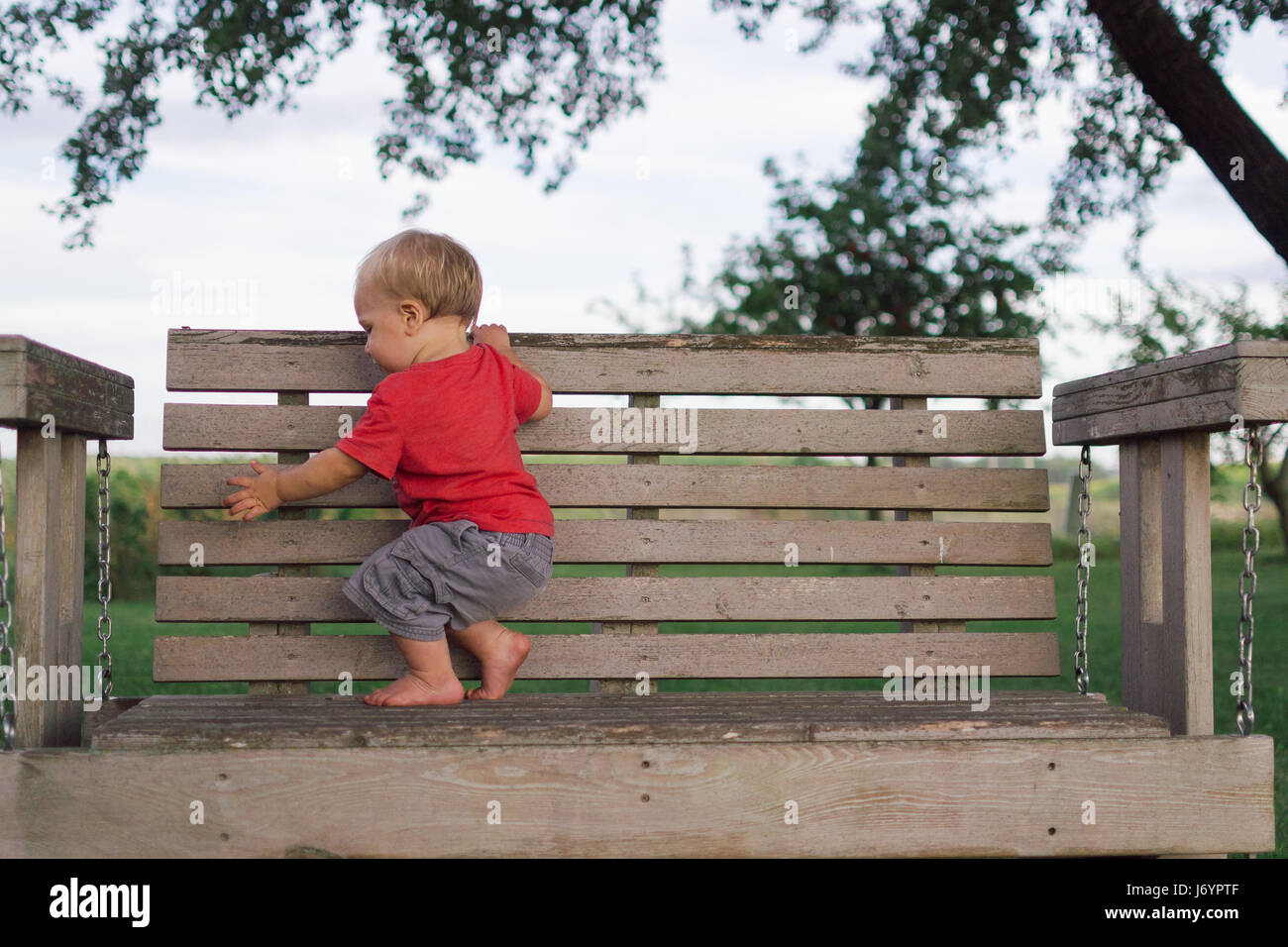 Toddler boy on bench hi-res stock photography and images - Alamy