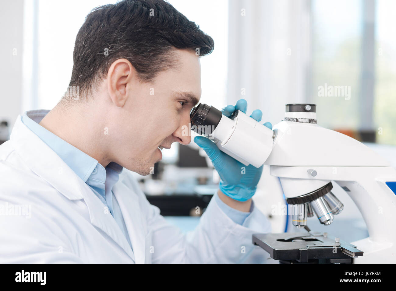 Portrait of delighted scientist while testing genetic code Stock Photo ...