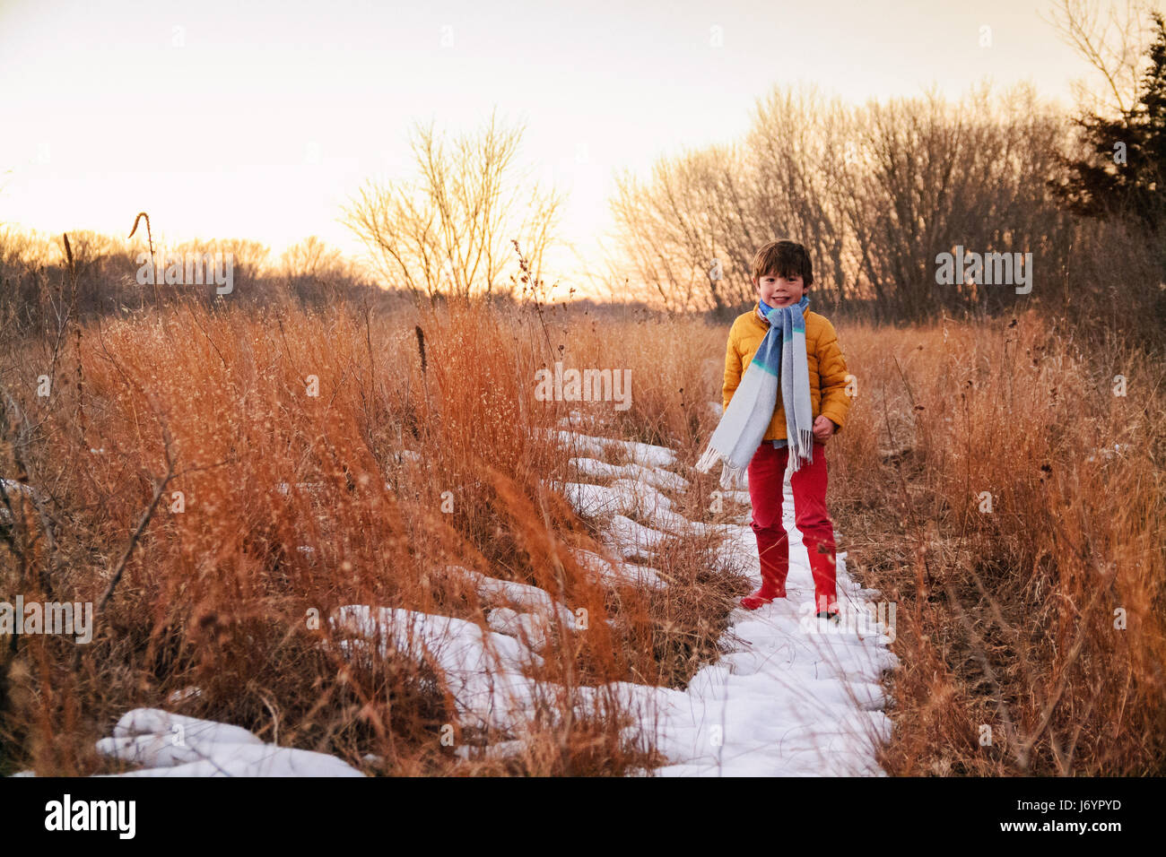 Boy standing in rural winter landscape Stock Photo - Alamy