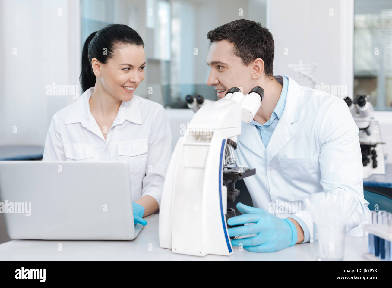 Positive delighted couple of analysts working together Stock Photo - Alamy