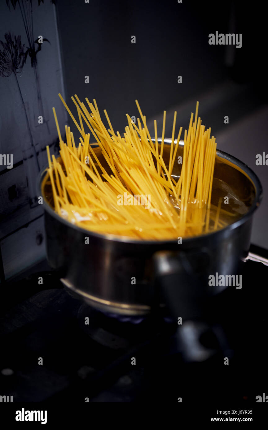 Spaghetti from durum wheat are cooked in a metal pot on the fire Stock ...