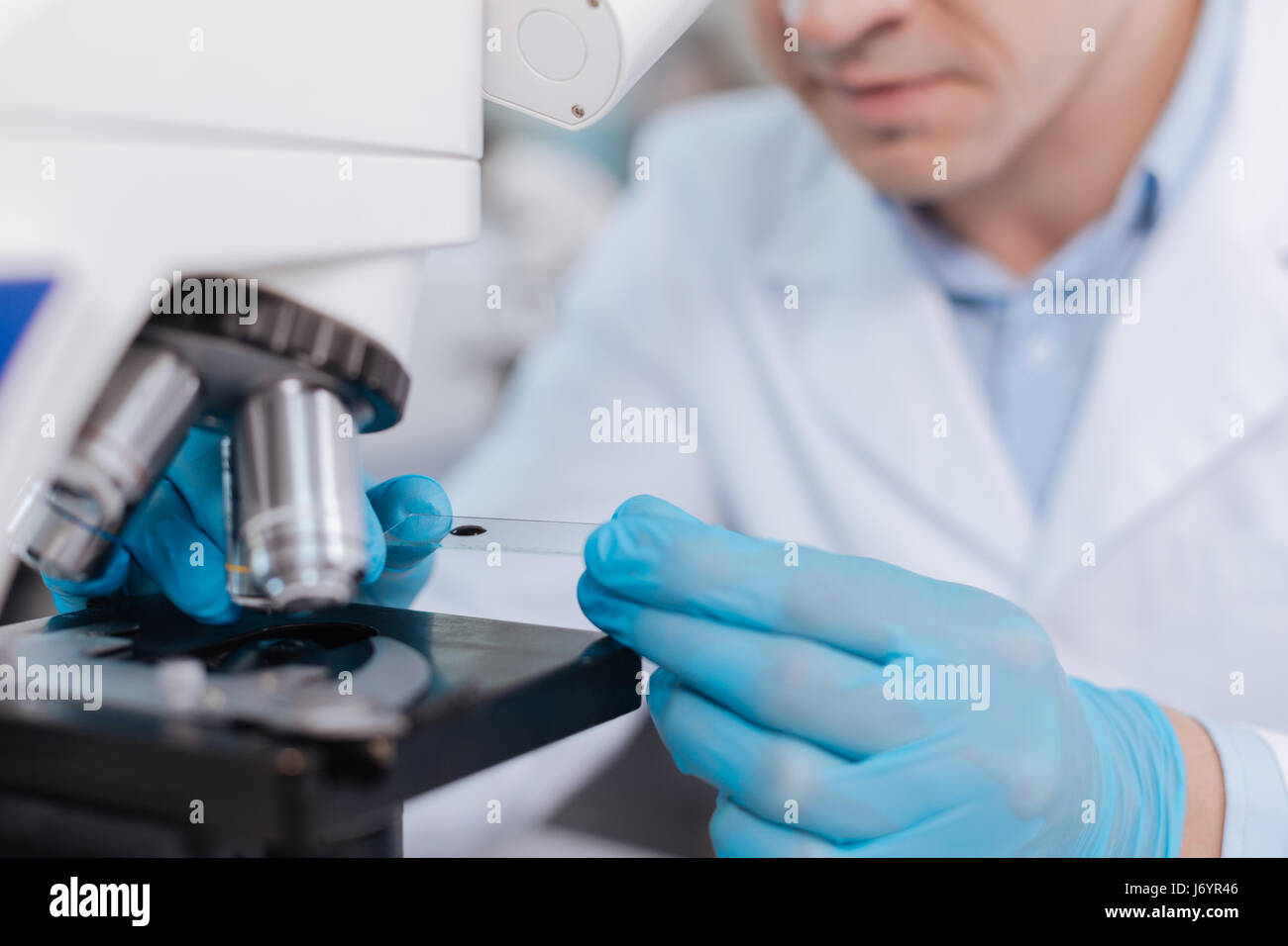 Attentive scientist looking into ocular Stock Photo - Alamy
