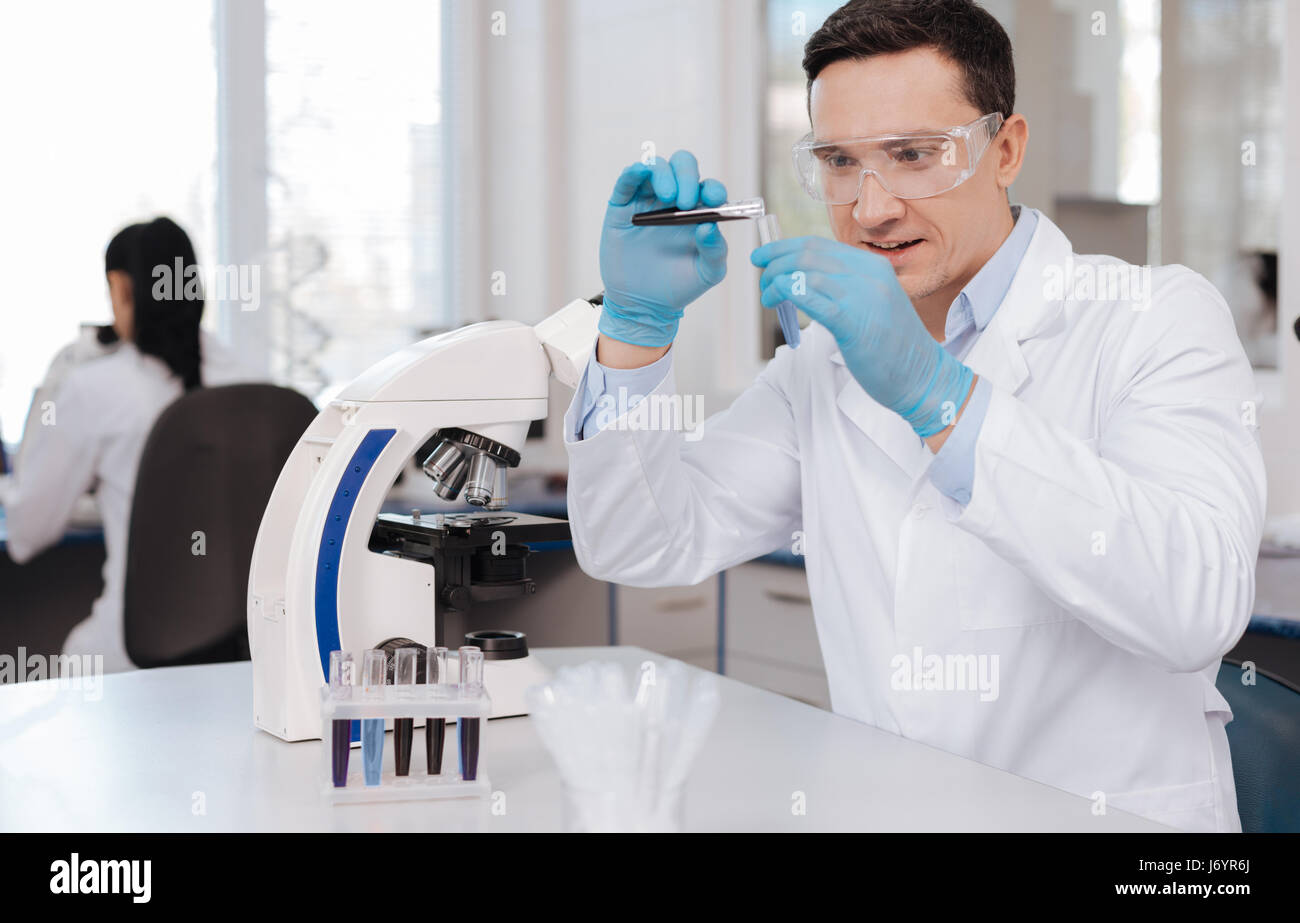 Handsome scientist inventing new formula Stock Photo - Alamy