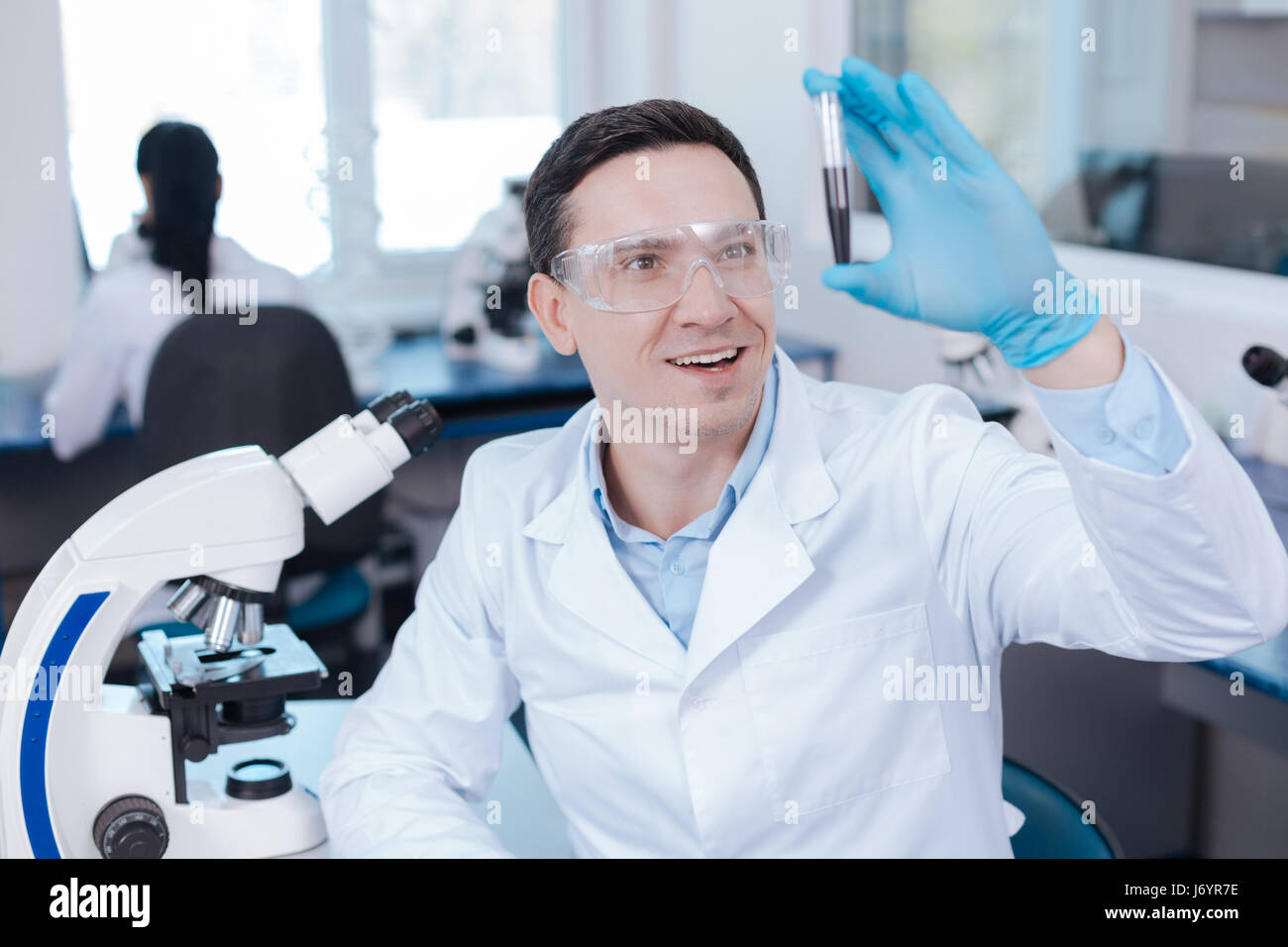 Handsome male person testing new chemical reagent Stock Photo - Alamy