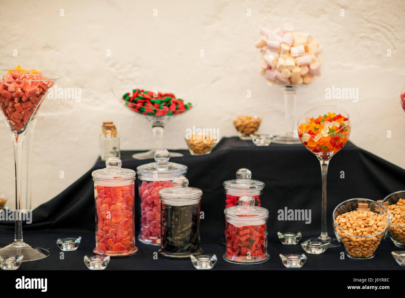 Candy bar table with jars of sweets Stock Photo - Alamy