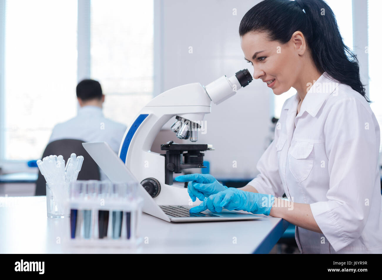 Woman scientist using computer microscope hi-res stock photography and ...