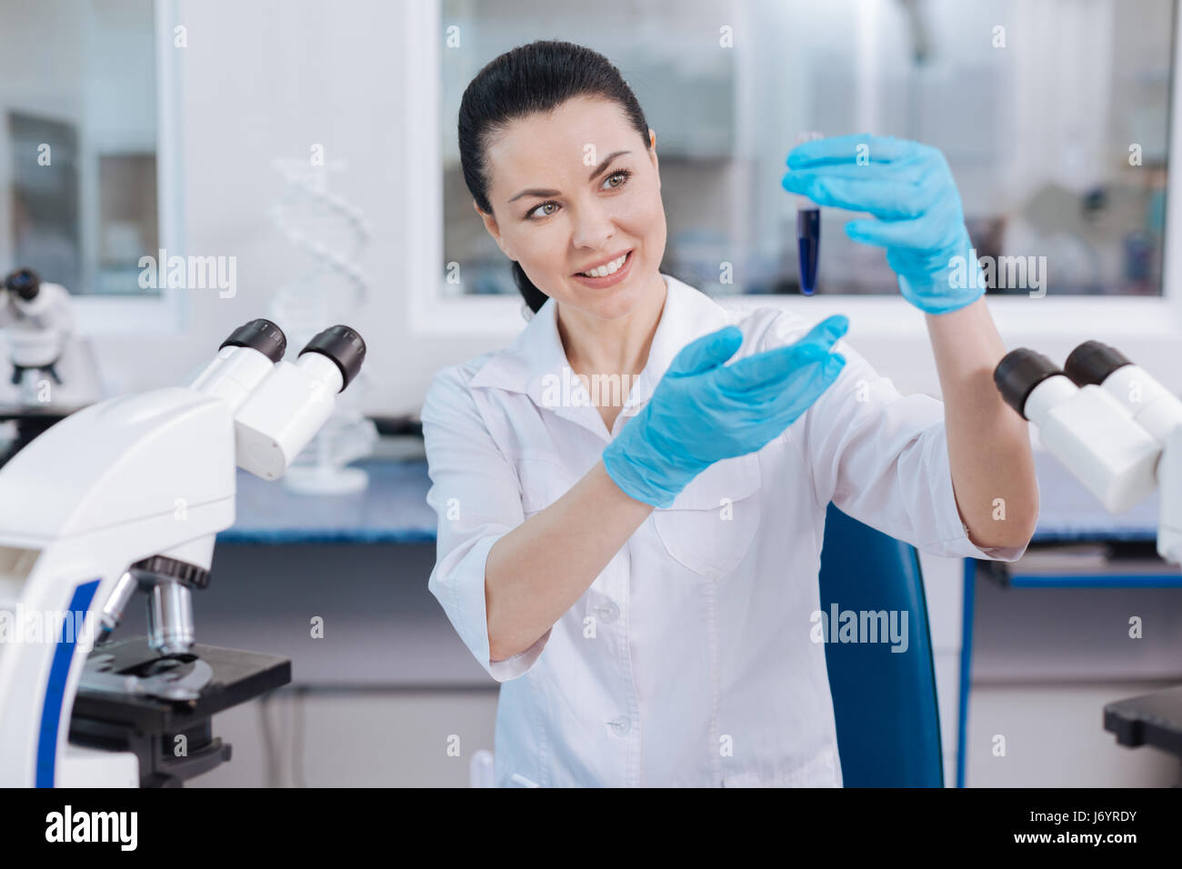 Attractive lab assistant turning her head aside Stock Photo - Alamy