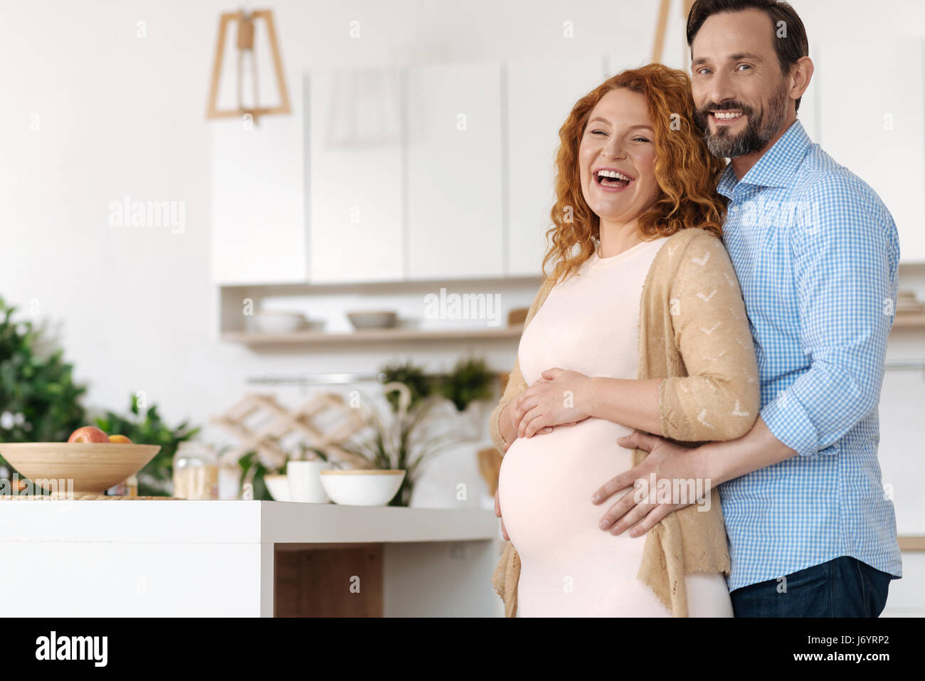 Radiant future parents posing together Stock Photo - Alamy