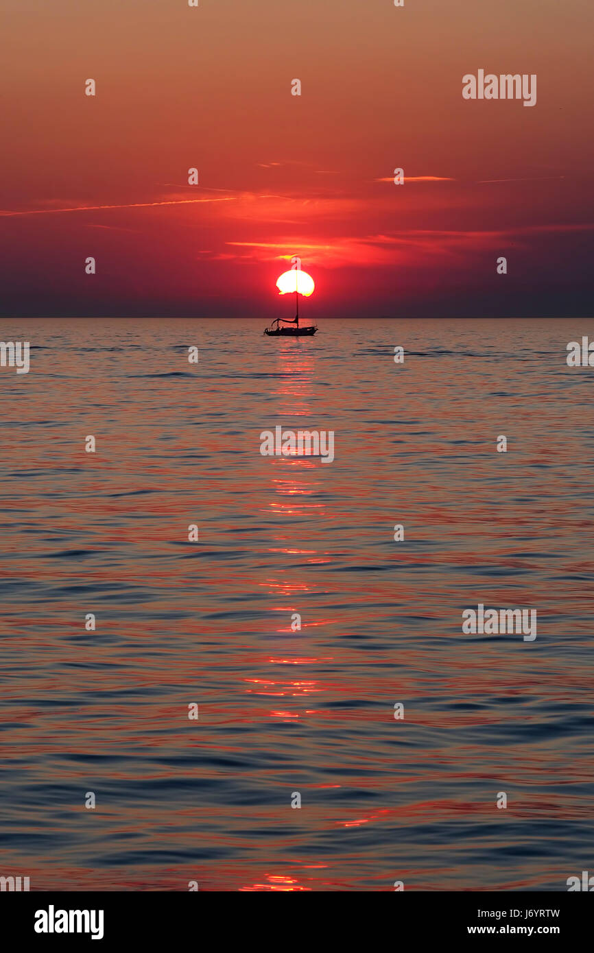 Boat in the sunset light Stock Photo - Alamy