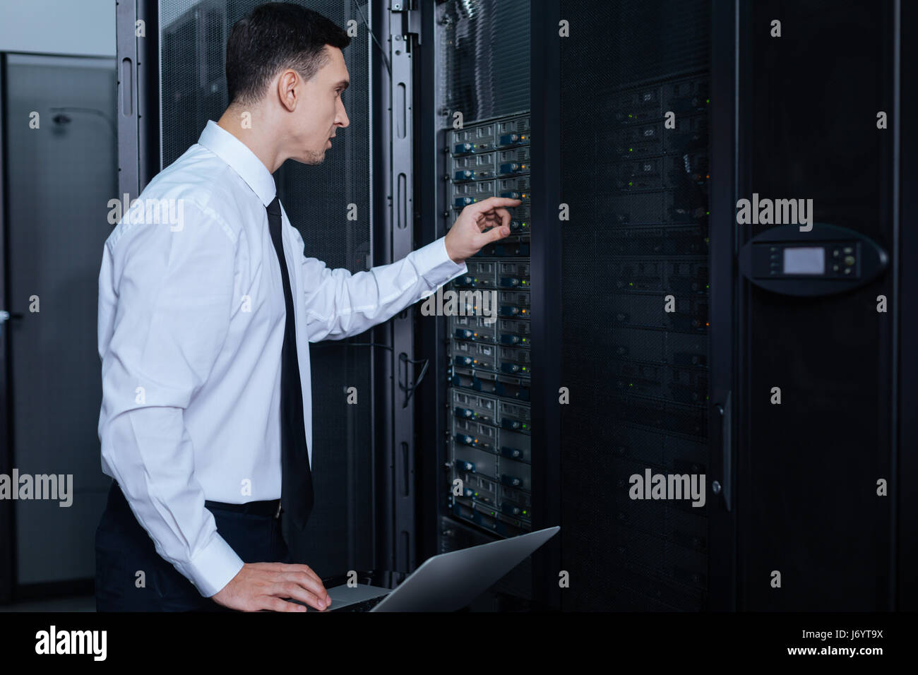 Pleasant handsome man pressing the button Stock Photo - Alamy
