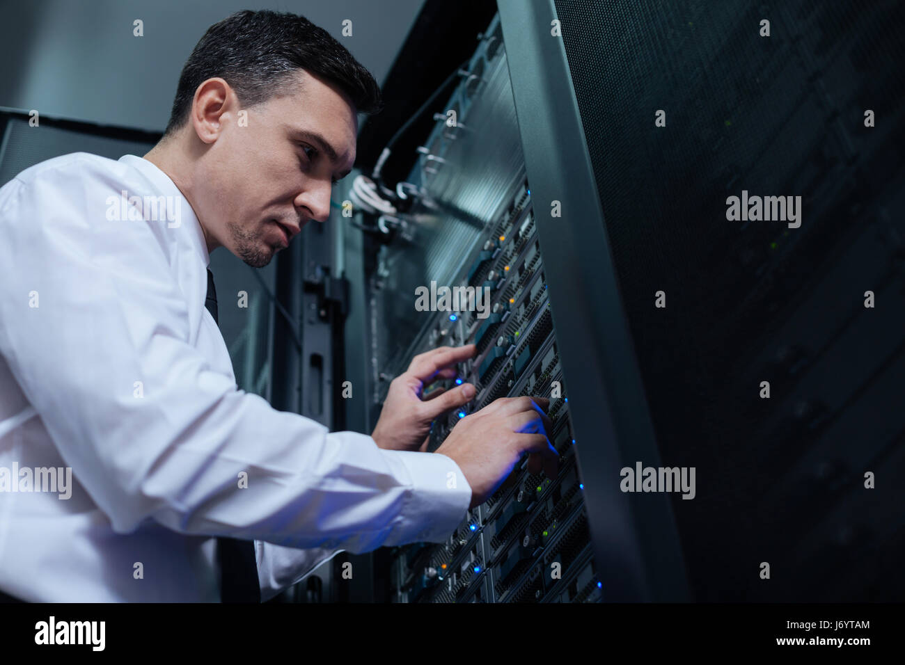 Professional computer engineer looking at the data server Stock Photo ...