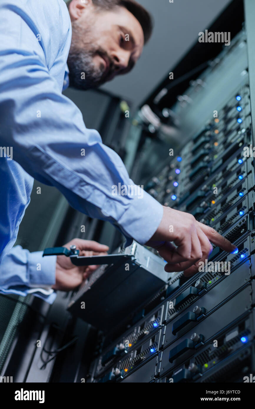 Handsome professional programmer doing the setting up Stock Photo - Alamy