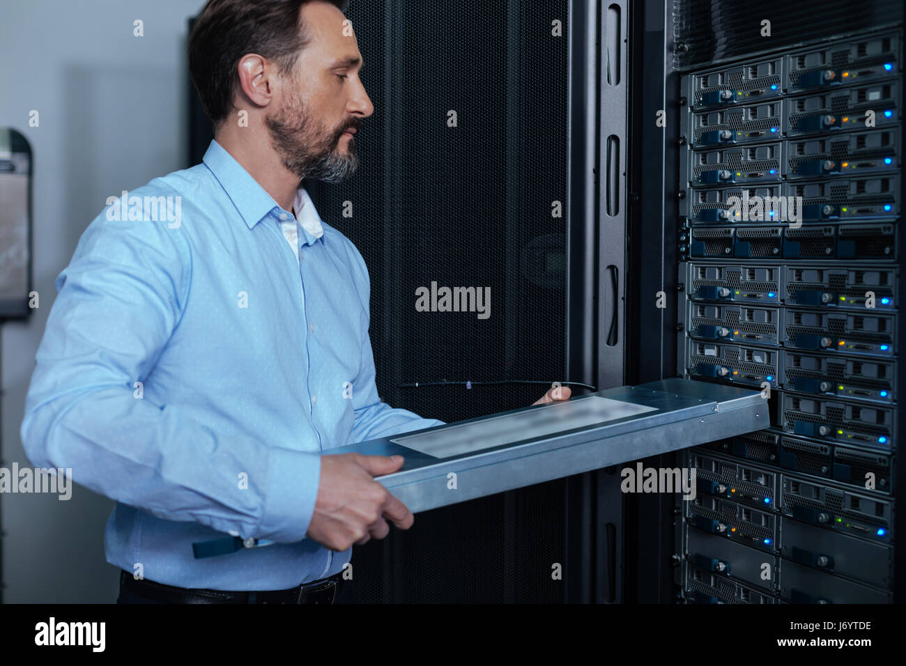 Serious bearded man doing his job Stock Photo - Alamy