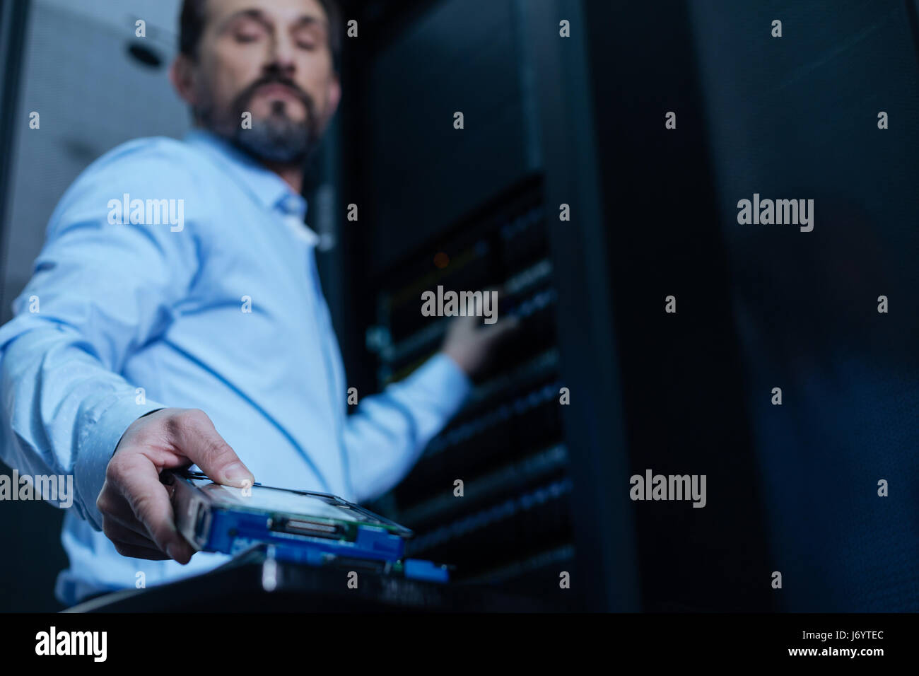 Handsome bearded programmer taking a rack server Stock Photo - Alamy