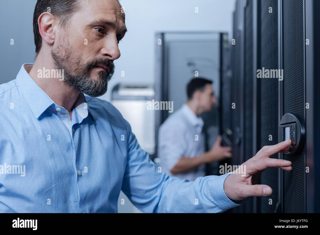 Handsome adult man pressing the button Stock Photo - Alamy