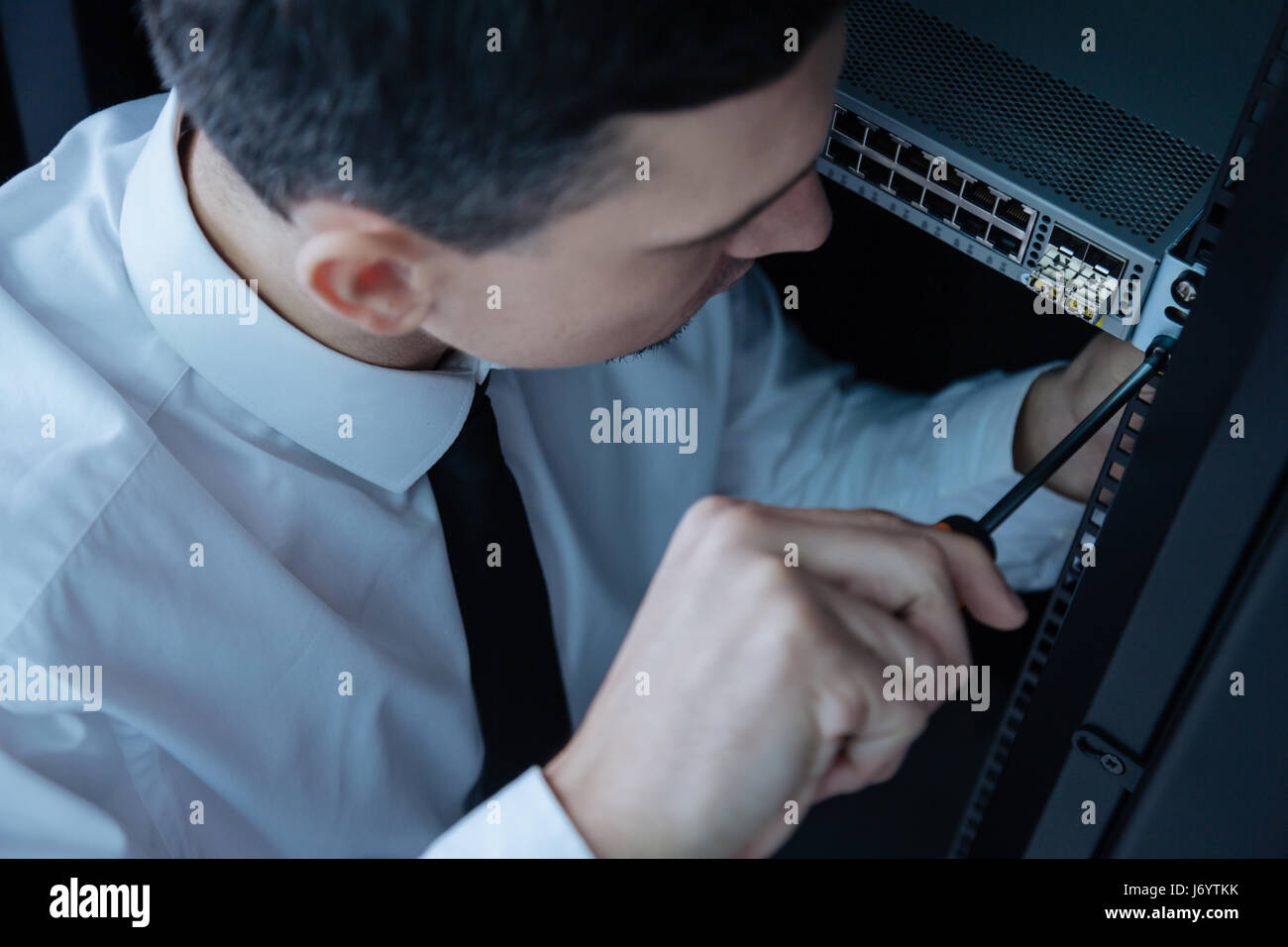 Professional male engineer turning a screwdriver Stock Photo - Alamy