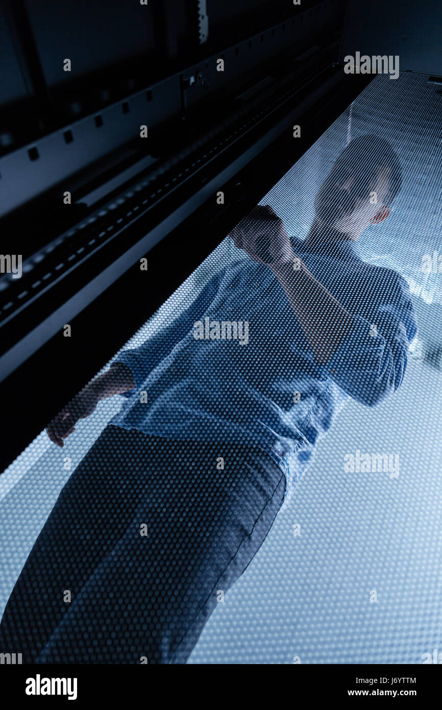Pleasant good looking man standing in the server room Stock Photo - Alamy